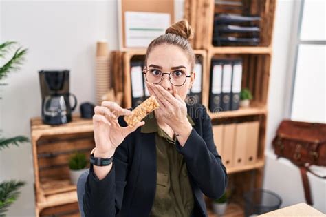 Young Hispanic Girl Eating Protein Bar As Healthy Energy Snack At The