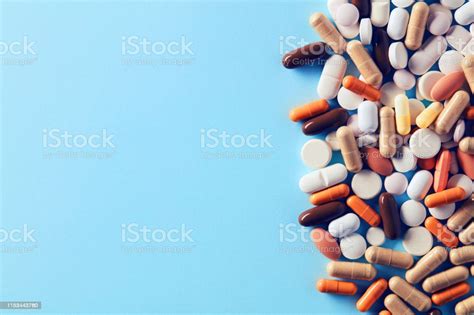 텍스트에 대 한 복사 공간 파란색 배경에 화려한 알 약 정제 및 캡슐의 스택 하향식 보기 0명에 대한 스톡 사진 및 기타 이미지