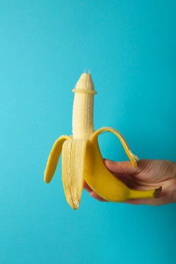 Premium Photo Female Hand Holding Condom On A Banana Safe Sex Concept