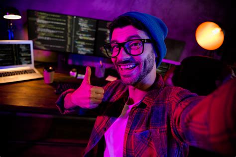Photo Of Confident Cool Coder Dressed Hat Eyewear Showing Thumb Up Recording Video Vlog Indoors