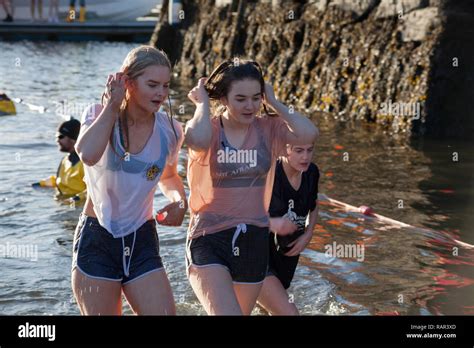Two Girls Emerging From The Water At The Annual New Years Day Swim At