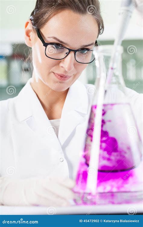 Scientist Putting Violet Liquid Into The Flask Stock Photo Image Of Glass Science