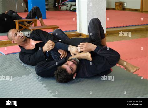 Two Men Practicing Brazilian Jiu Jitsu Wrestling At The Academy Stock