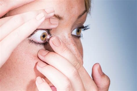 Premium Photo Close Up Of Woman Applying Contact Lens
