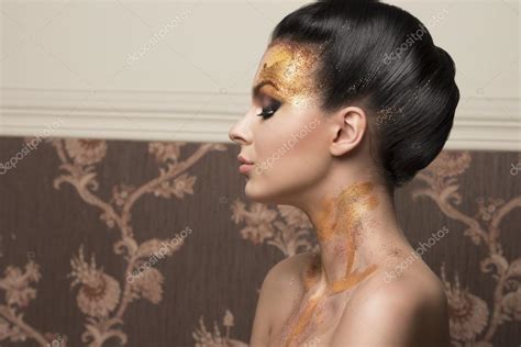 Girl In Profile With Golden Make Up Stock Photo Carlodapino