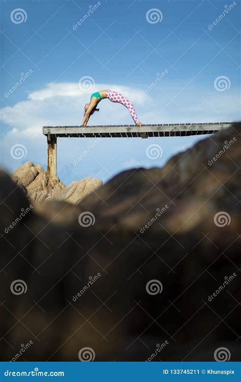 Woman Relaxing Vacation Playing Yoga Pose On Beach Pier Stock Image
