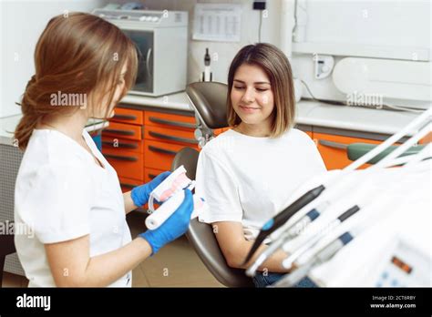 The Doctor Shows The Patient How To Properly Brush His Teeth With An