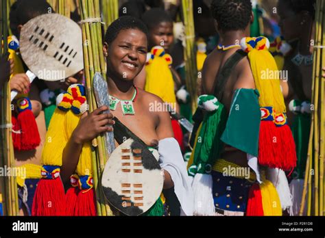 Swazi Girls Carrying Reeds And Shield Made Of Animal Skin Parade At