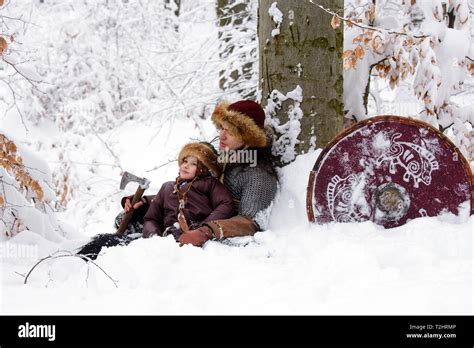 Father And Son Vikings In A Deep Winter Forest And The Father Teaches