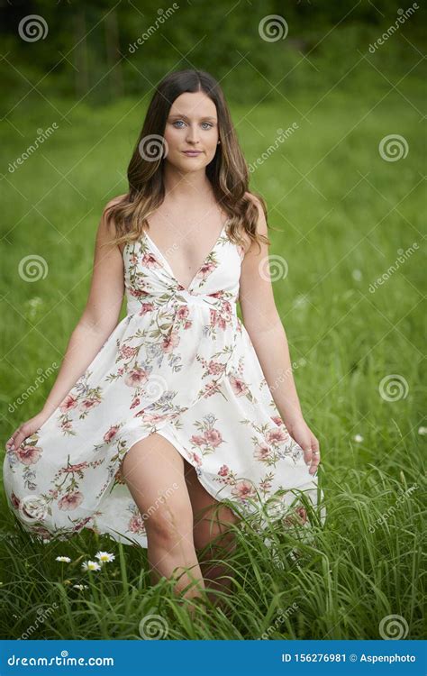 Beautiful Young Woman Walking In Sundress In Field Of Grass Stock Image