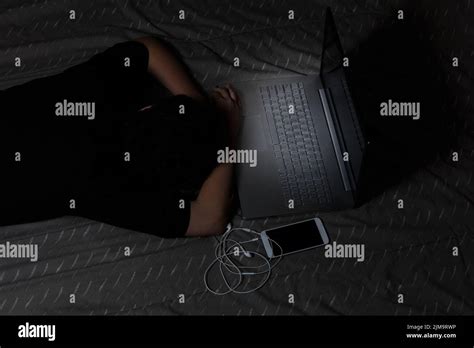 Teen Girl Falls Asleep While Using Laptop Computer During Her Bedtime