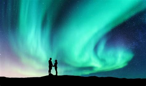 Premium Photo Northern Lights And Hugging Couple On The Hill