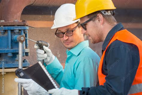Babe Men And A Woman Are Standing Near A Gas Pipe With An Analyzer And Documents They Are