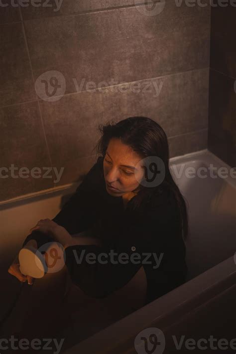 Upset Woman Sitting With Arms Wrapped Around Legs In Tub 46452342