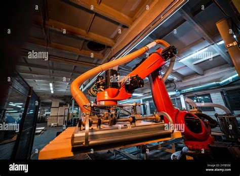 A Robotic Arm In A Woodworking Factory Equipped With Suction Technology Lifts And Processes