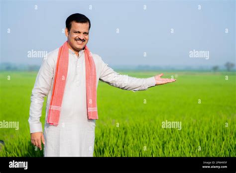 Happy Smiling Indian Village Farmer Showing Crop By Looking At Camera