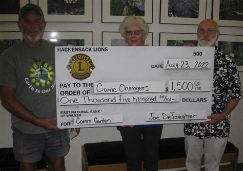 Presenting The Check To Jim Etzel From Left And Karen Holle Is Don