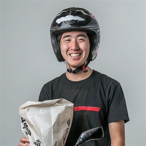 A Man Wearing A Helmet And Holding A Paper Bag Premium Ai Generated Image
