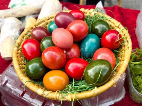 Colorful Assorted Eggs In Woven Basket On Red Fabric Background Stock