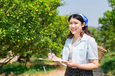 Young Women Plant Scientist Work In Orange Farm Female Working Collect