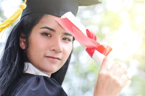 Premium Photo Portrait Of Smiling Young Woman In Graduation Gown