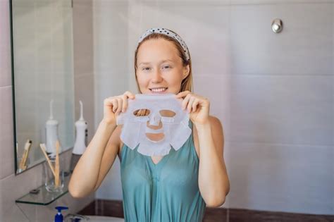Premium Photo Young Redhaired Woman Doing Facial Mask Sheet Beauty