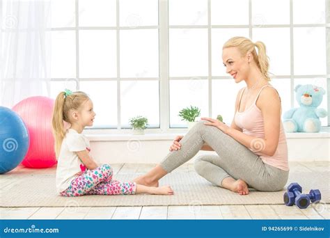 Young Mother And Daughter Exercise Together Indoors Stock Image Image