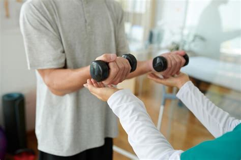 Premium Photo Physiotherapist Helping Patient