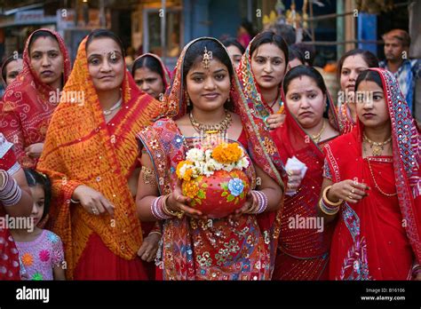 Rajasthani Women Carry A Clay Pot Through The City As Part Of The