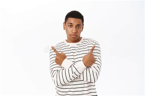 Complicated Black Man Pointing Sideways Showing Left And Right Way