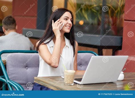 Pleased Delighted Gorgeous Female Model Speaks Via Mobile Phone With