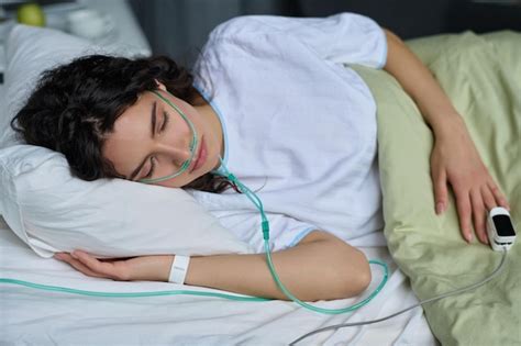 Premium Photo Young Woman Sleeping With Oxygen Tube On Bed In