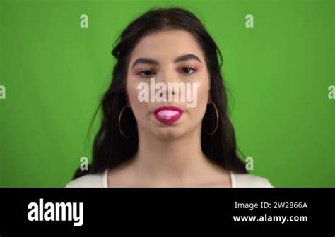 Sexy Girl Blowing Bubbles Gum Chewing Gum On Green Screen Slow Motion