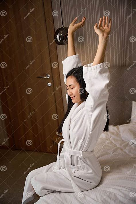Beautiful Asian Woman In Bathrobe Stretching Body After Sweet Dreaming