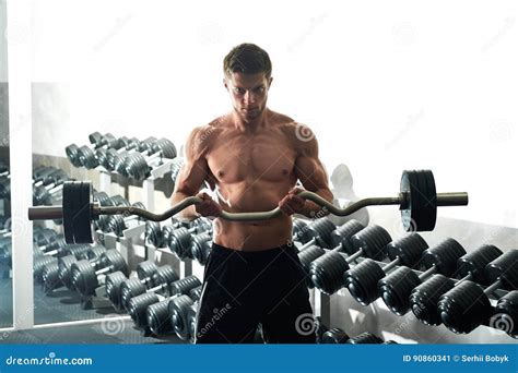 Young Fitness Man With Muscular Body Exercising With Ez Curl Bar Stock