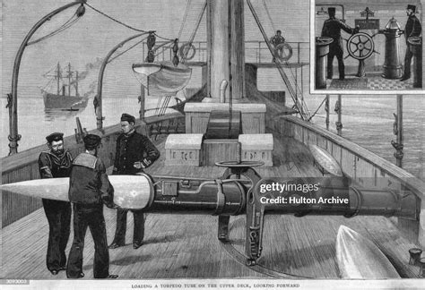 A View Looking Forward Of Sailors Loading A Torpedo Tube On The Upper