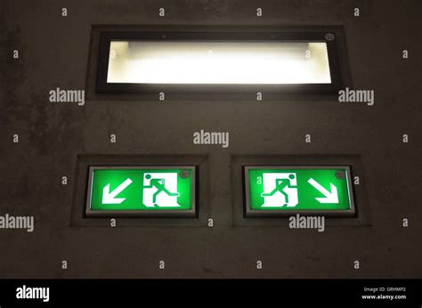 Two Way Green Exit Sign On Concrete Wall Stock Photo Alamy