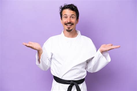 Premium Photo Young Caucasian Man Doing Karate Isolated On Purple
