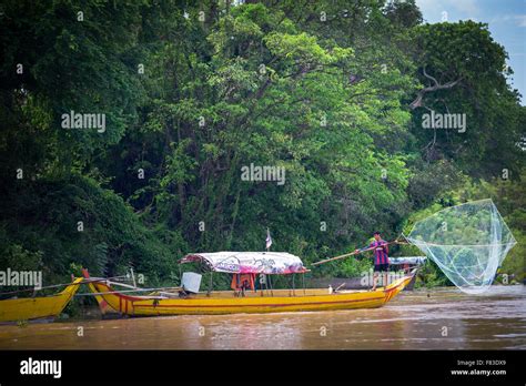 On The Mekong River A Cambodian Fisherman With His Large Fishing Net Kratie Cambodia