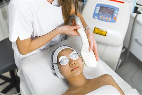 High Angle Shot Of A Woman Lating Down And Receiving An Erbium Yag