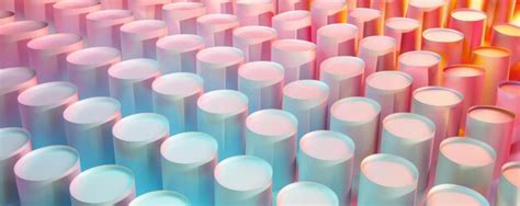A Simple Grid Pattern Of Cylinders And Squares On A Pastel Background