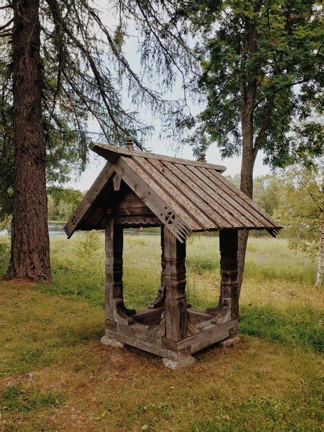 Premium Photo Built Structure On Field By Trees Against Sky