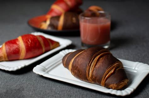 Premium Photo Chocolate And Red Croissants Lie With A Glass Of Juice