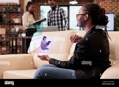female employee talking to ai hologram using artificial intelligence