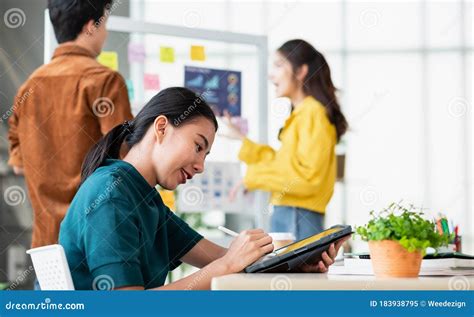 Asian Ux Developer And Ui Designer Using Tablet Testing Mobile App Interface Design With