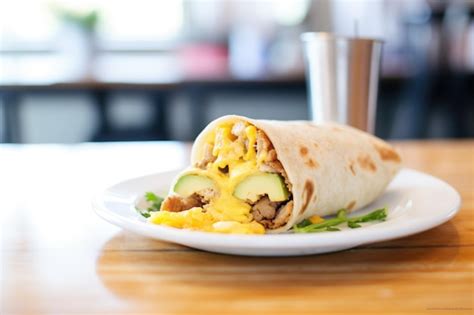 Premium Ai Image Breakfast Burrito With Egg Cheese And Sausage
