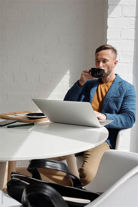man using notebook in coffee house by stocksy contributor clique