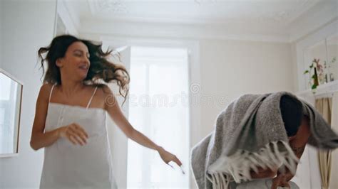Playful Pair Jumping At Bed Closeup Pyjamas Couple Having Fun Playing