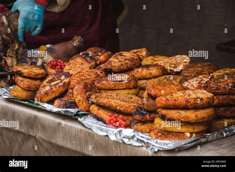 Smoking Bio Natural Seasoned Cheese With Spices In A Smoker In A Street