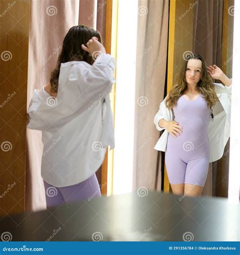 Young Girl In Fitting Rooms Puts On Sports Tight Suits Clothes New With